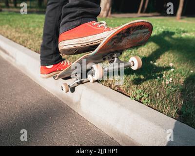Skateboarder make back slide trick on park Stock Photo - Alamy