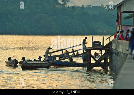 People on a boat jetty on Segah river in Tanjung Redeb, Berau, East ...