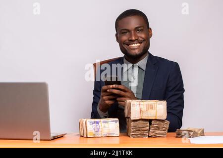excited african businessman with a lot of money making a phone call ...