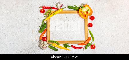Assorted fresh vegetables and spices around wooden frame. Ripe yellow ...