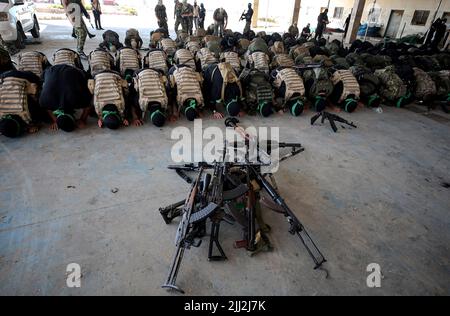 Armed men from the Izz al-Din al-Qassam Brigades, the military wing of ...