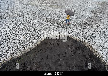 Cracked dry farmland under scorching sun, symbolizing drought, climate ...