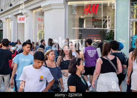 Pedestrians walk past a Swedish multinational clothing-retail company ...