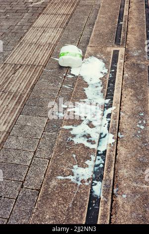 Milk spilled on a path (Jul22 Stock Photo - Alamy