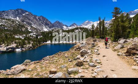 Woman backpacking along Box Lake in Little Lakes Valley, John Muir ...