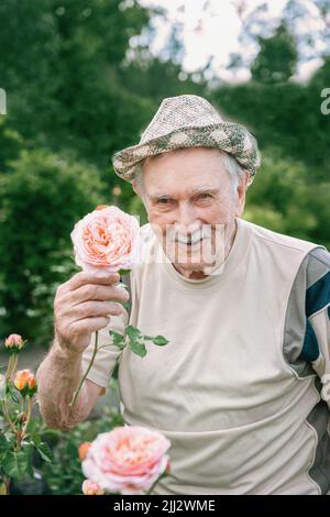 portrait of man gardener smelling flowers Stock Photo - Alamy