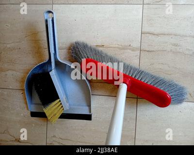 Trash Bin And Sweeper On Floor In A Room Stock Photo - Alamy