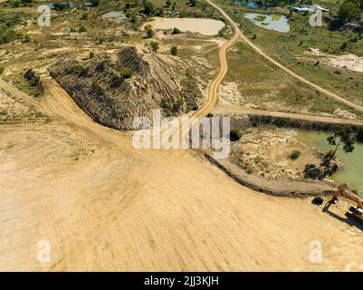 A huge mound of dirt piled after miners dig for sapphires on the ...