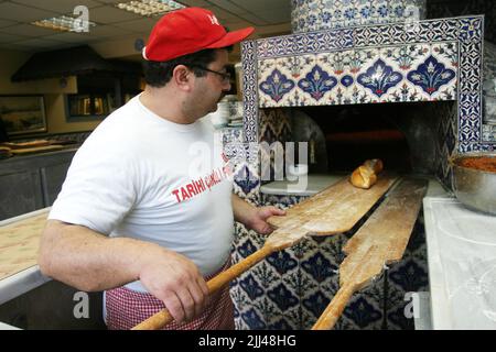 ISTANBUL, TURKEY - MAY 14: A baker making Turkish bread on May 14, 2016 ...