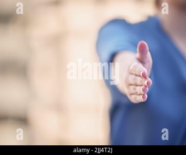 Ready to bring you aboard. a businesswoman with her hand outstretched ...