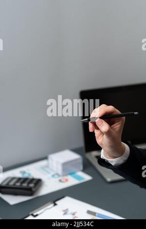 Businesswoman Pointing With Pen On Important Messages On Desk With ...