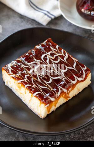 Trilece dessert. Slice of dessert with caramel and milk on a dark ...