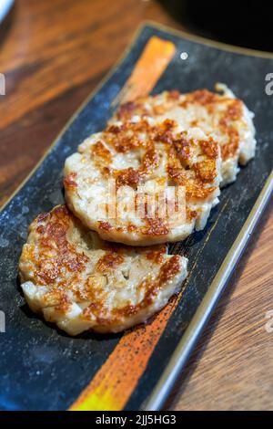 A delicious pan-fried lotus root cake Stock Photo - Alamy