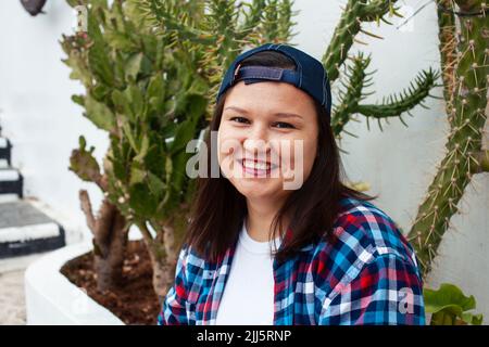yound pretty american woman siting smiling among cactuses, lifestyle ...