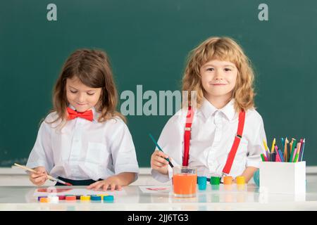 Portrait school kids doing art homework. Children drawing on elementary ...