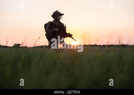 A critical skills operator patrols alongside explosive ordnance ...