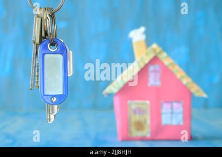 latchkey with key fob and blurred home in the back,buying house,real ...