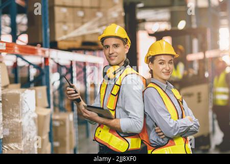 Girl with cardboard standing with male worker in small winery cellar ...