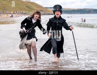Emma Parfett and Shaun Smith paddle in the sea during the Whitby ...