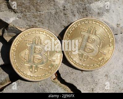 two coins with the capital letter B symbolizing the cryptocurrency ...
