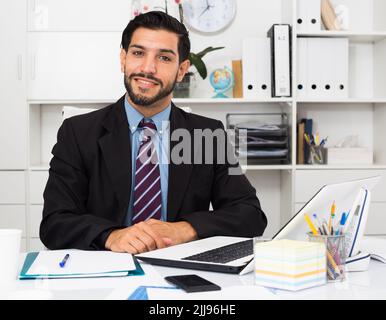 Spanish man is having a productive day at work in office Stock Photo ...