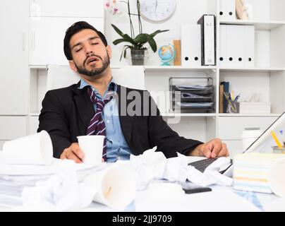 Businessman is resting after productive work day in office Stock Photo ...