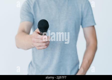broadcaster media man holding microphone interview Stock Photo - Alamy