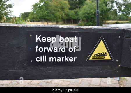 Warning sign 'Keep boat forward of cill marker' on a UK canal lock gate ...