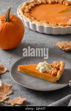 Happy Thanksgiving. Pumpkin pie slice on modern plate on rustic table ...