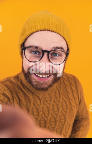 Bearded ginger man holding his head and looking at camera isolated over ...