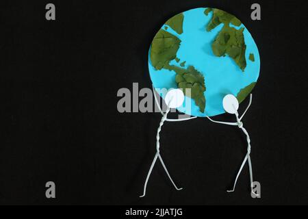 Human stick figure man carrying the earth on his shoulders on dark ...