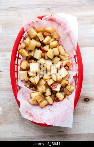 cubed potato in a dish on a wooden board Stock Photo - Alamy