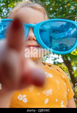 Children enjoy nature in glasses. Selective focus. Nature Stock Photo ...