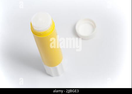 Opened yellow glue stick on white background Stock Photo - Alamy