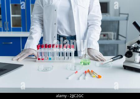 Scientist standing near laptop and microscope in laboratory Stock Photo ...