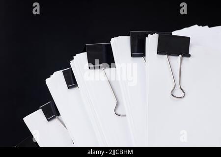 Blank Office papers fastened with black binders Stock Photo - Alamy