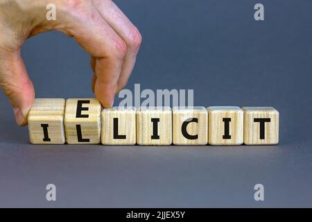Illicit or elicit symbol. Businessman turns wooden cubes and changes ...