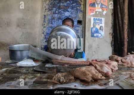 Millicent Awuor, a business woman sells deep fried chicken to locals at ...