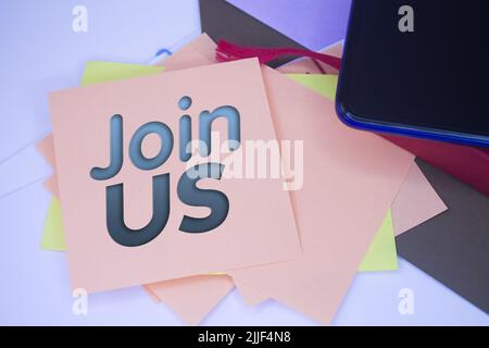 Join Us. Text on adhesive note paper. Event, celebration reminder ...