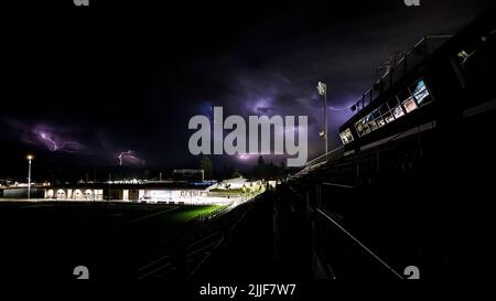 Lightning strikes over the stadium as the teams are forced off by rain ...