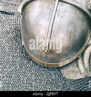 Ancient Roman retro chain mail made of metal plates and a dagger in a ...