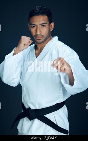 Male karateka, fighter practice in white kimono, combat stance, dark ...