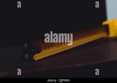 Measuring tape on black background Stock Photo - Alamy