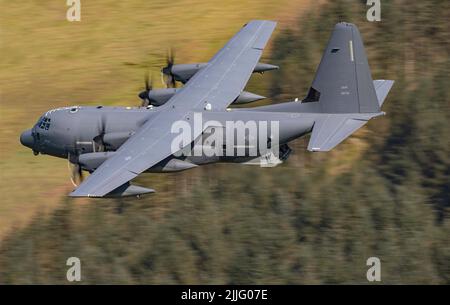 A closeup of Lockheed Martin MC-130J Commando II in a flight on green ...