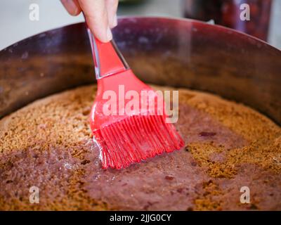 Woman spreading gluten free cake mixture in two tins Stock Photo - Alamy