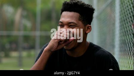 Young black man bursting laughing out loud outside. Person real life ...