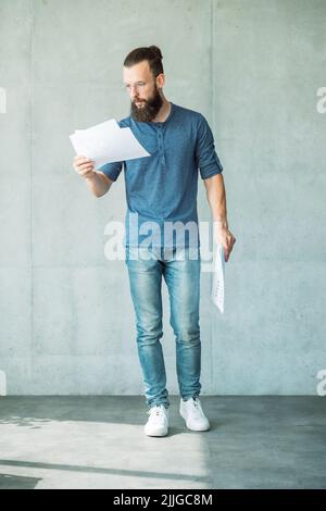 focused man read document information report data Stock Photo - Alamy