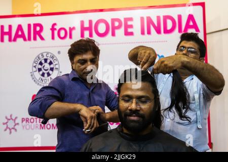 Hairdressers prepare the hair of a youth donor before snipping off during a donation drive to support cancer survivors organized by Hair for Hope India foundation s Cut a thon event in New Delhi. As