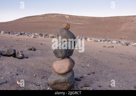 Rock cairns built by visitors at the prehistoric Giant of the Atacama ...