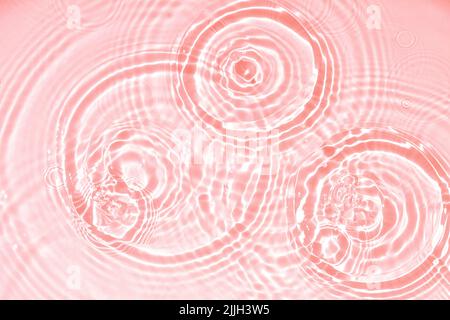 Pink water texture, cosmetic background pink water surface with rings ...